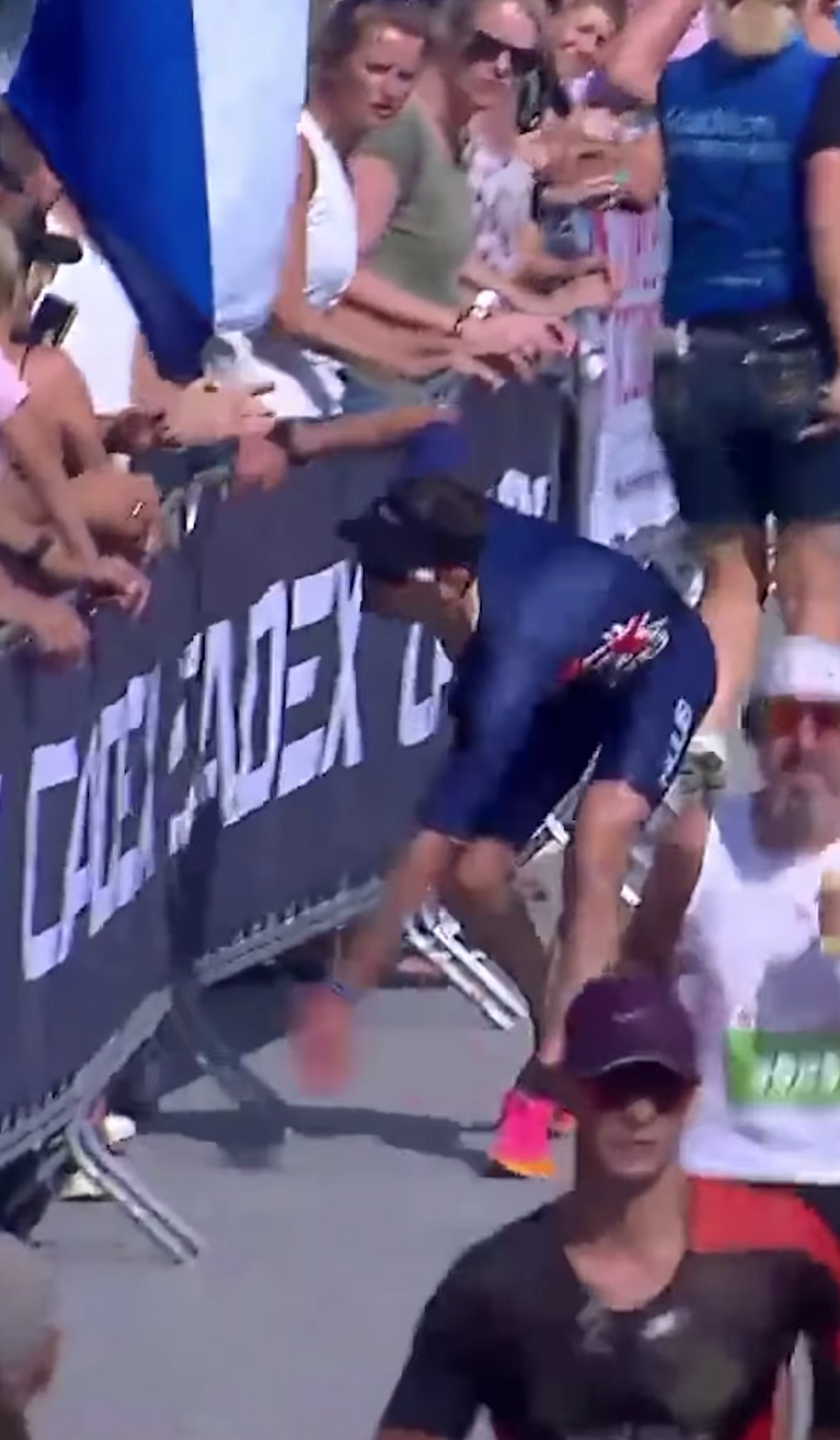Watch: Moment triathlete 'loses control of body', almost collapses on ...