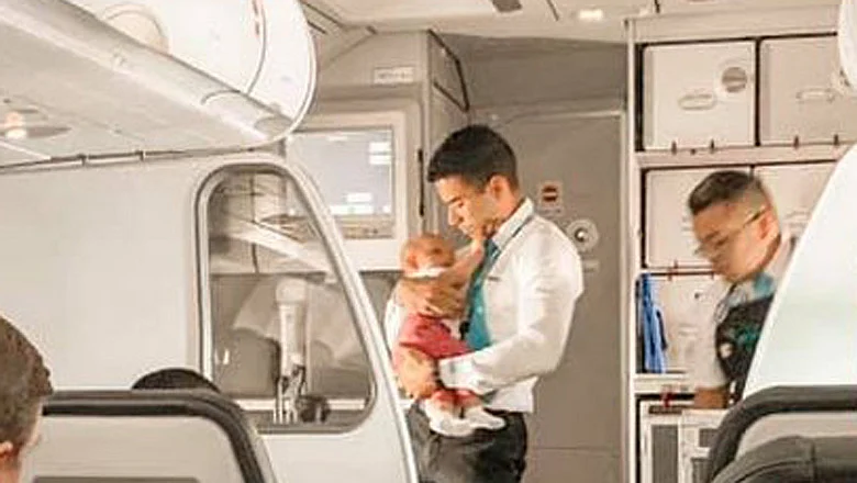 Male flight attendant helps mother comfort crying baby, photos go viral